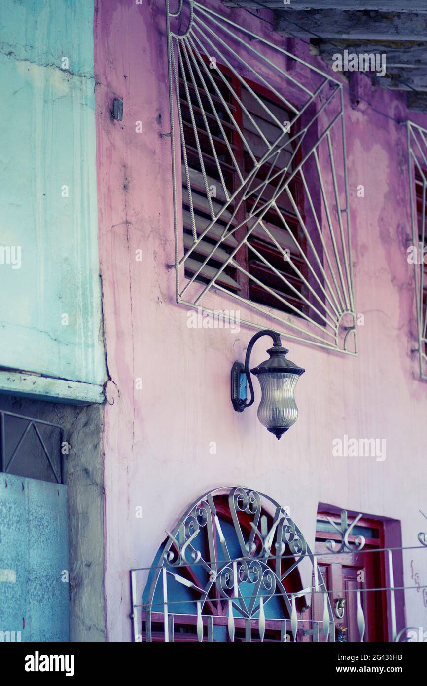 Outdoor lamp and part of a gate and window of an old building in Havana ...