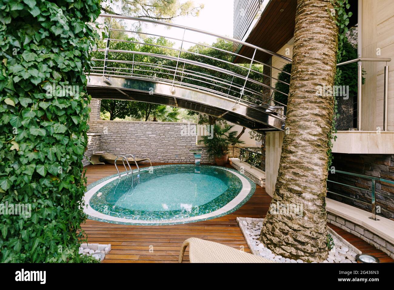 The oval turquoise swimming pool at the villa Stock Photo - Alamy