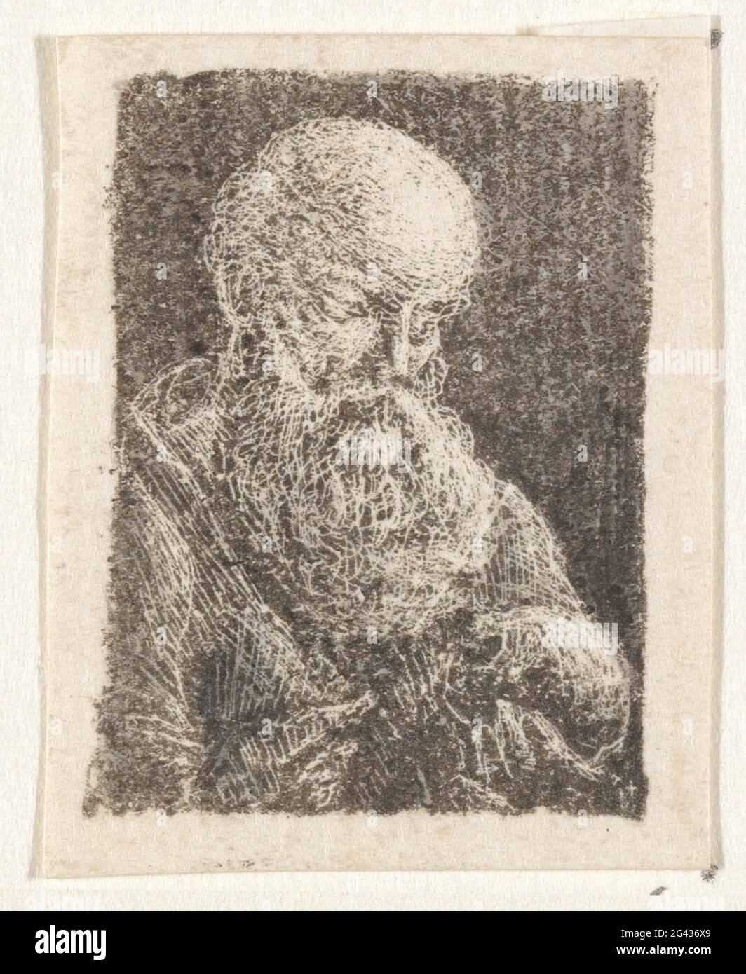 Old man with skull. The man has a beard and a bald head. He looks at ...