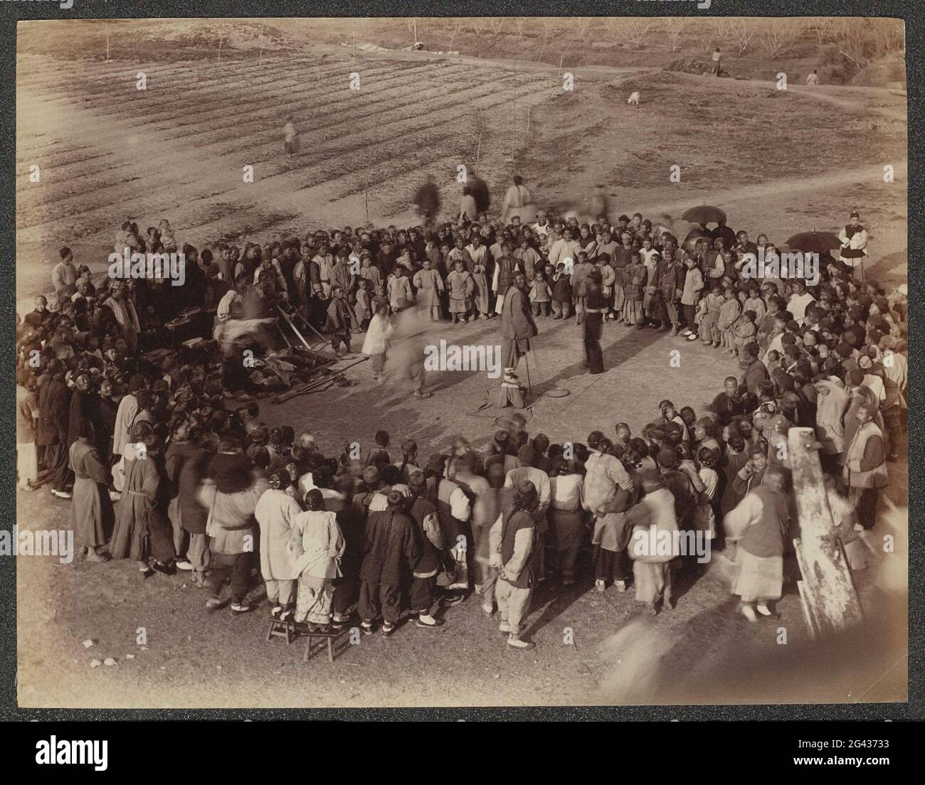 Chinese in a circle at a party game outdoors. Part of album with 50 ...
