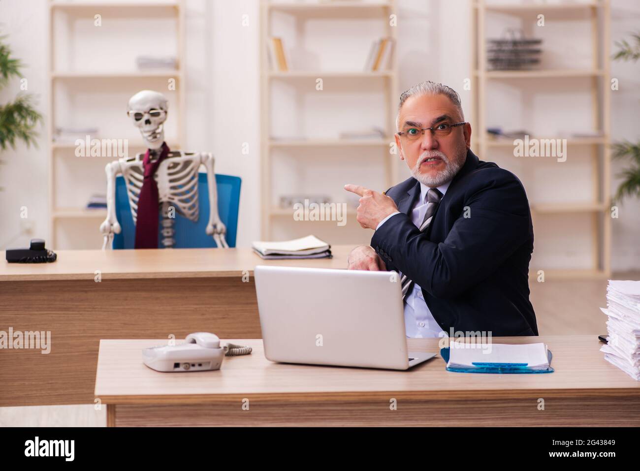 Dead employee working in the office Stock Photo - Alamy