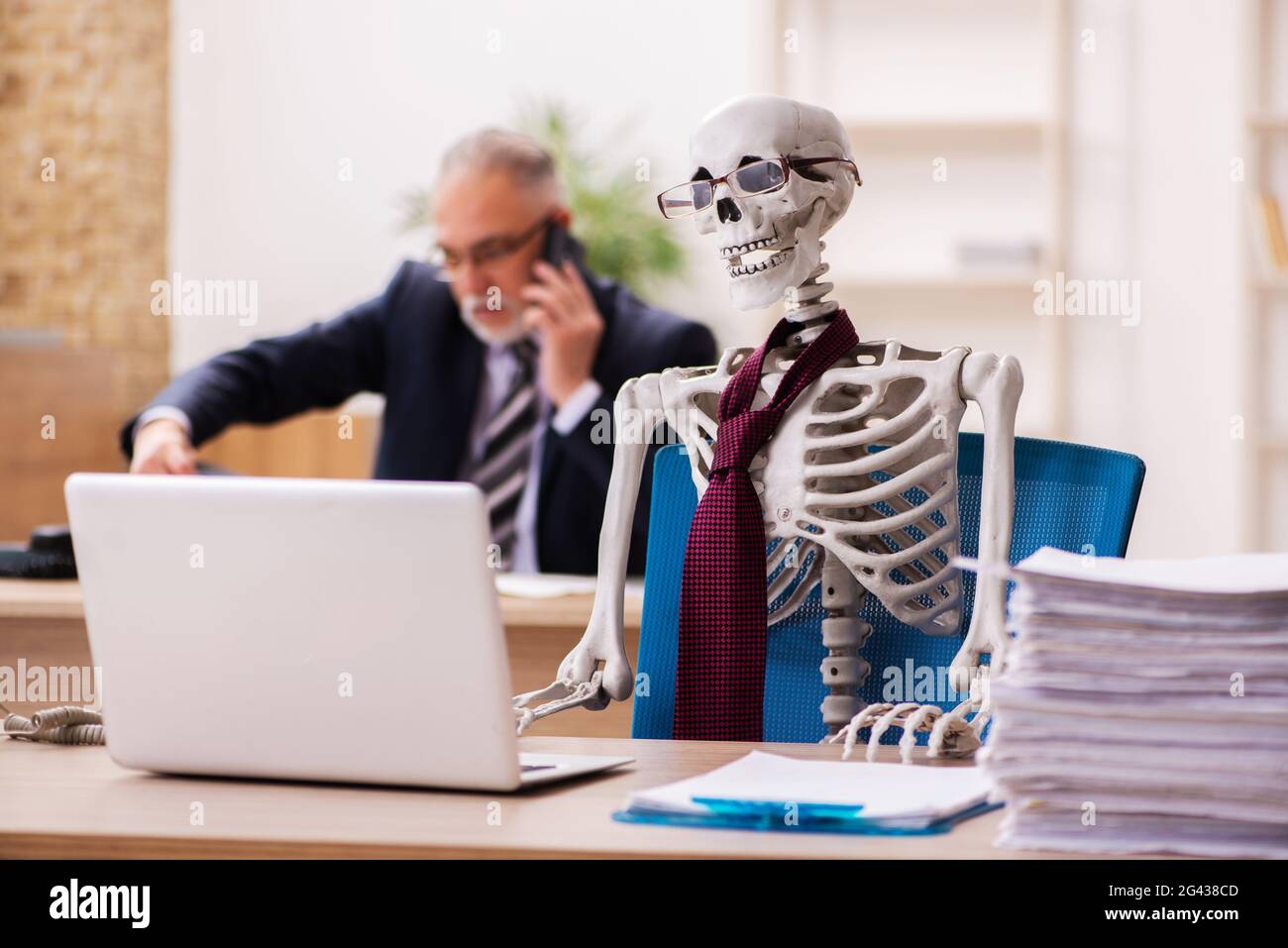 Dead employee working in the office Stock Photo - Alamy