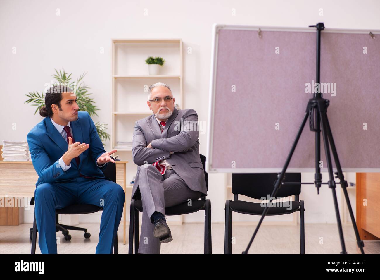 Two male employees in business meeting concept Stock Photo - Alamy