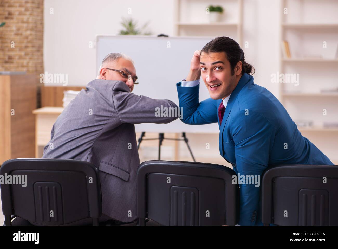 Two male employees in business meeting concept Stock Photo - Alamy