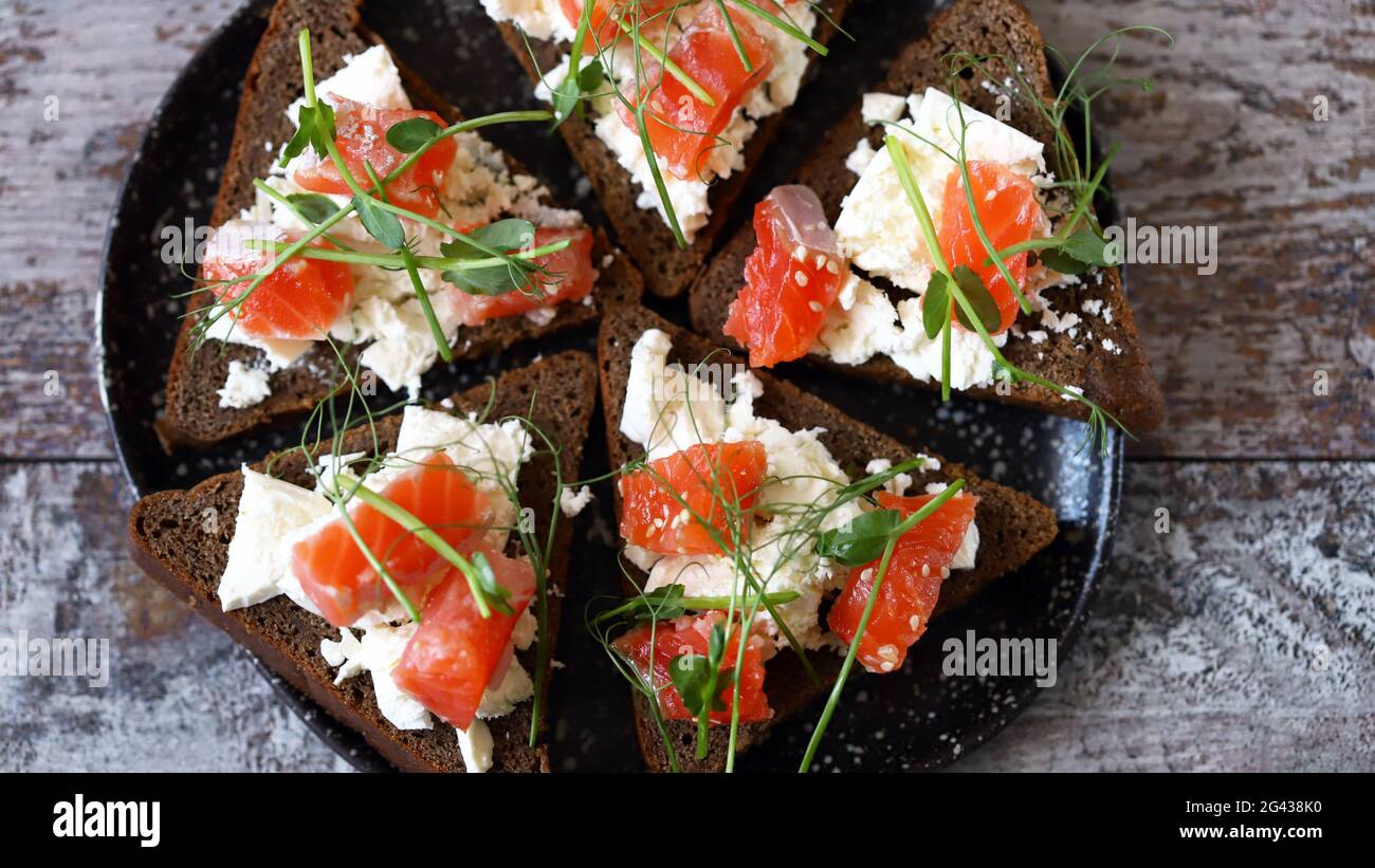 Keto diet. Keto snack. Plate with toasts with salmon and white cheese ...