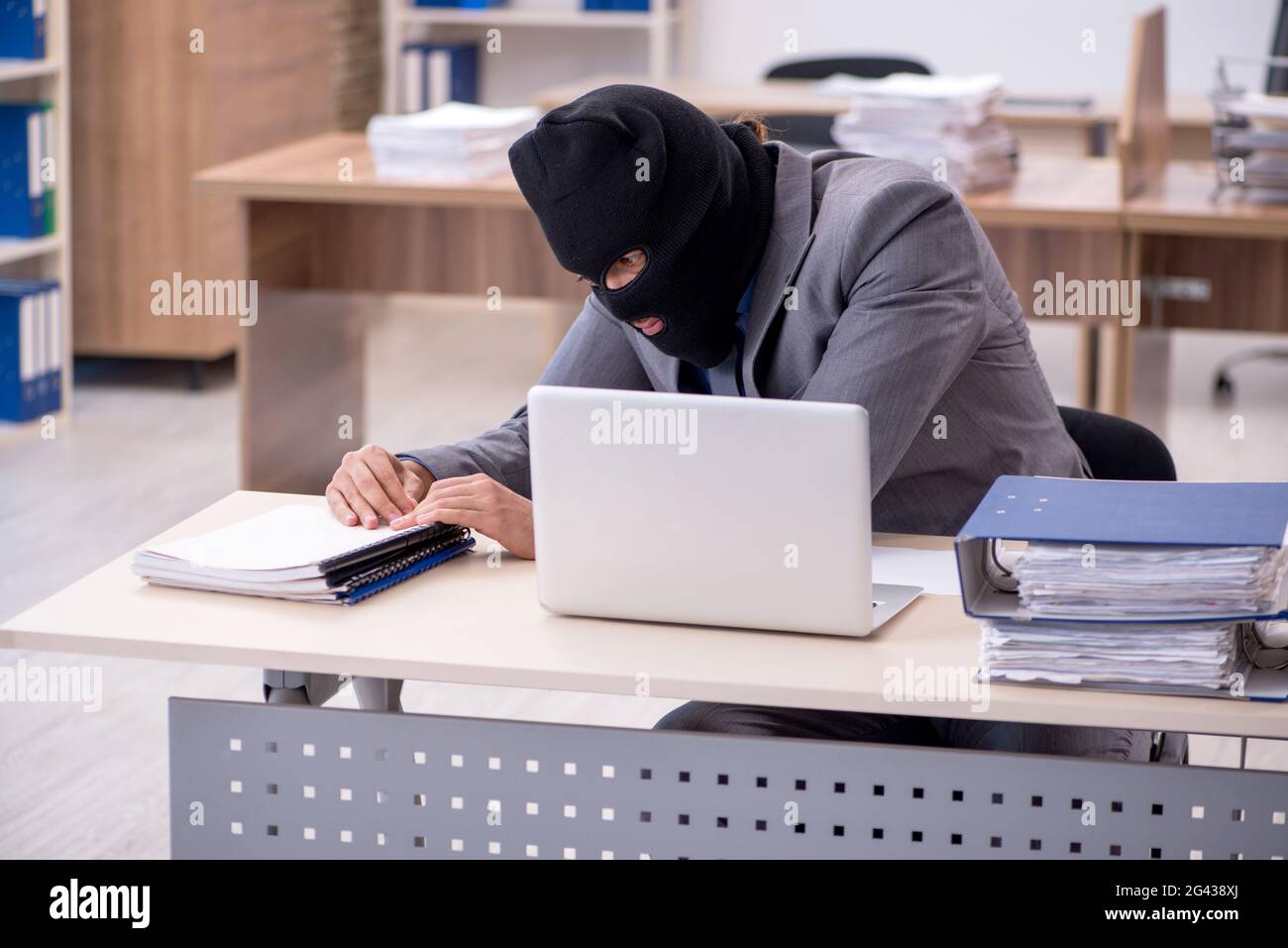 Young male employee in industrial espionage concept Stock Photo - Alamy