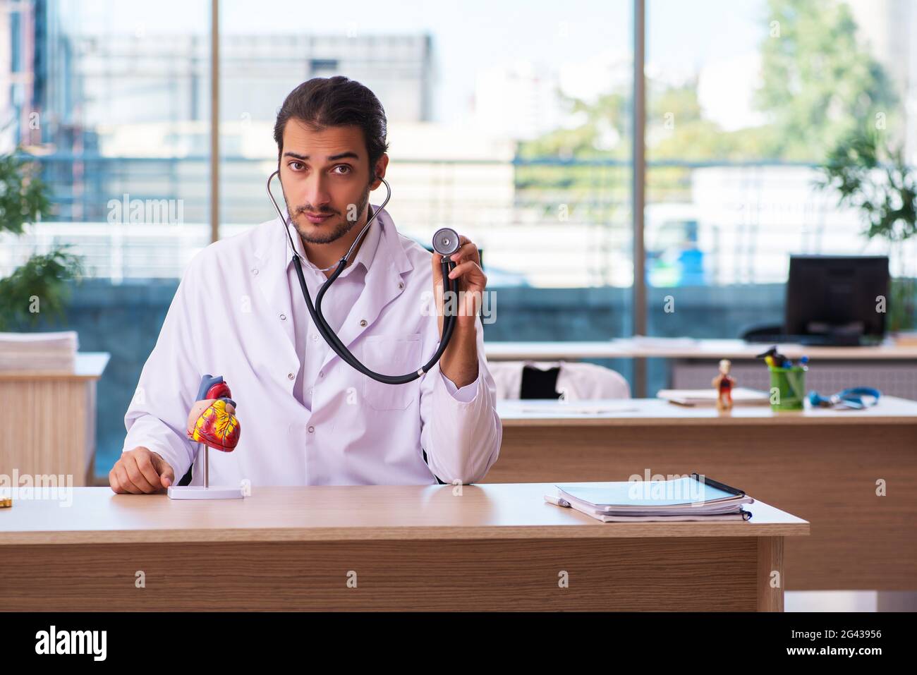 Young male doctor cardiologist working in the clinic Stock Photo - Alamy