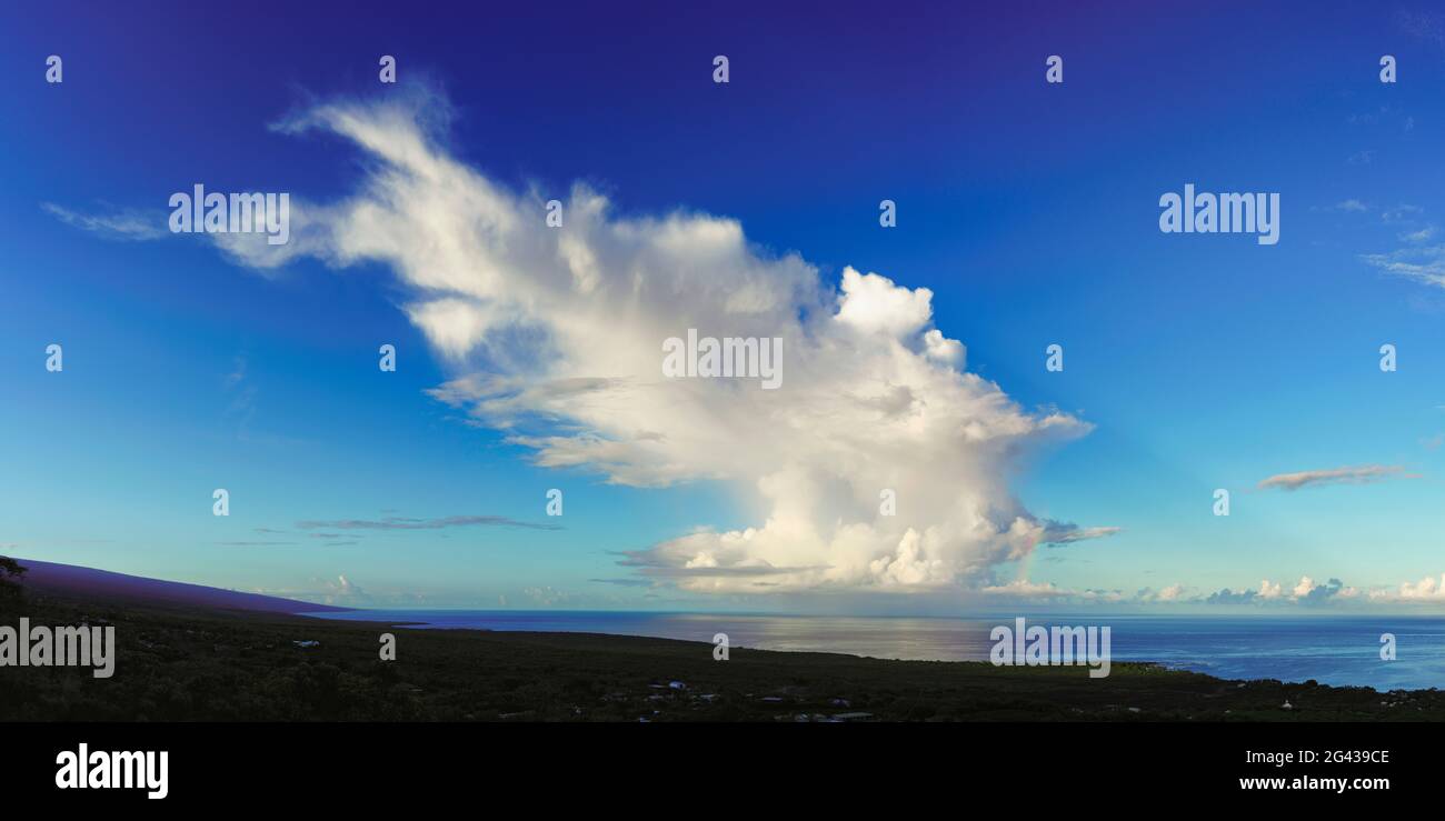 Cumulus cloud and blue sky above Pacific Ocean coastline, South Kona ...
