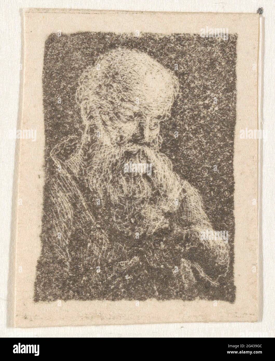 Old man with skull. The man has a beard and a bald head. He looks at ...