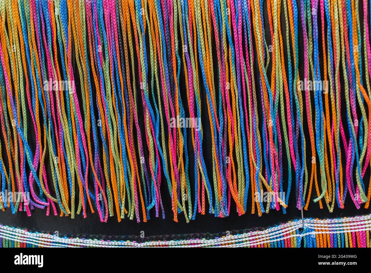 Lots of colorful braided strings on display Stock Photo - Alamy