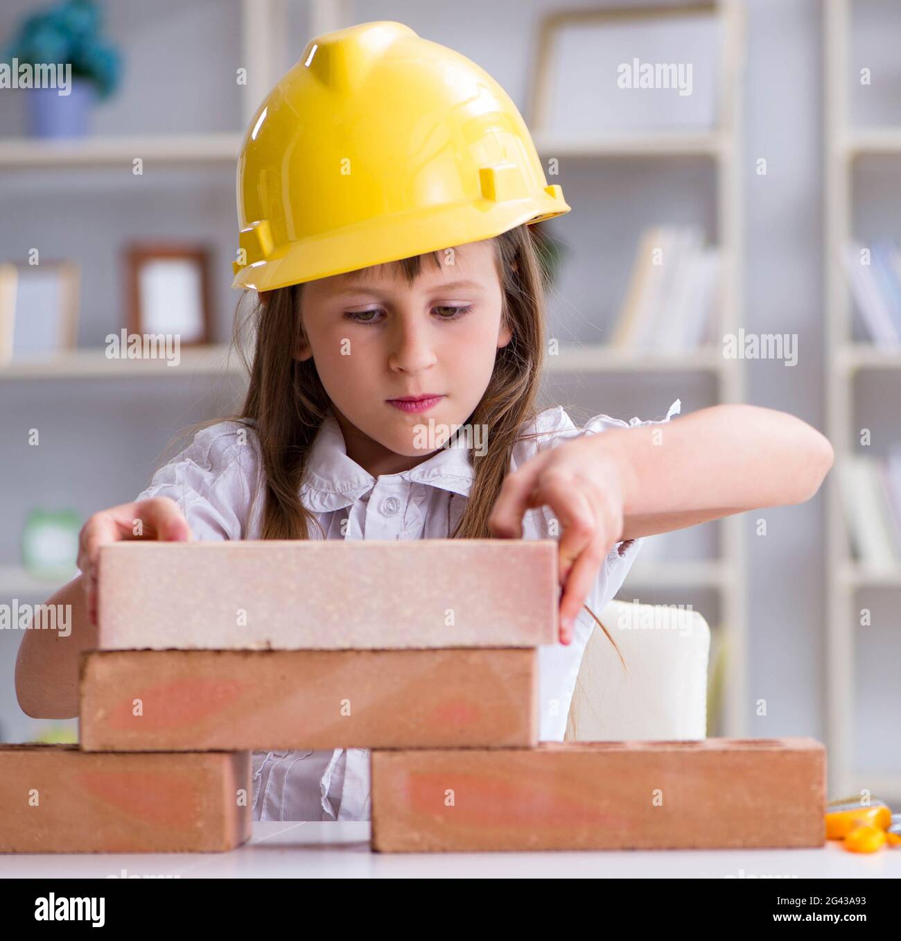 Young girl building with construction bricks Stock Photo - Alamy