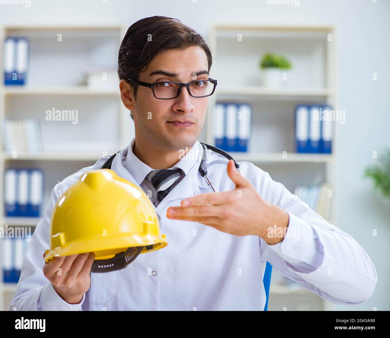 Safety doctor advising about wearing hard hat Stock Photo - Alamy