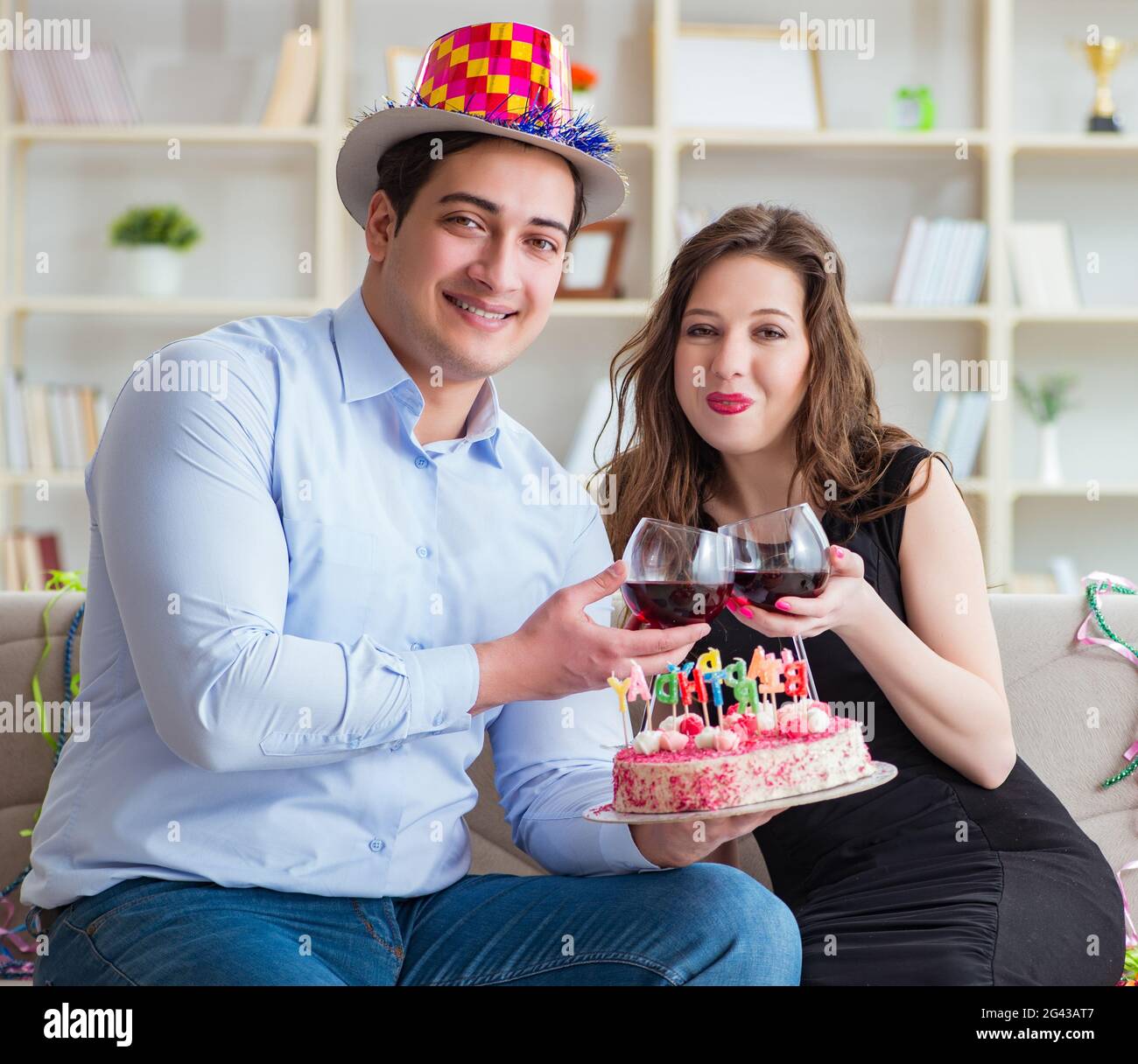 Young couple celebrating birthday with cake Stock Photo - Alamy