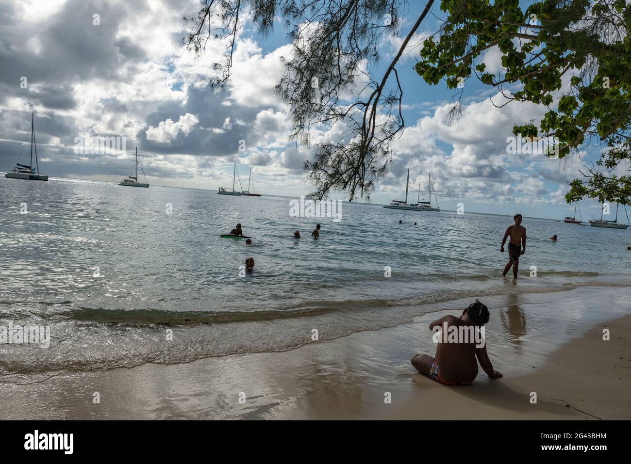 Locals swim and have fun on a popular swimming beach in Opunohu Bay ...