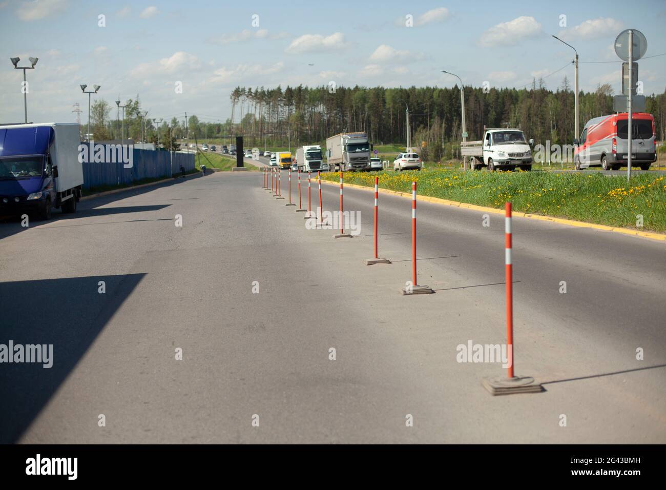Red parking stops. Fencing the carriageway from cars. Bright orange ...