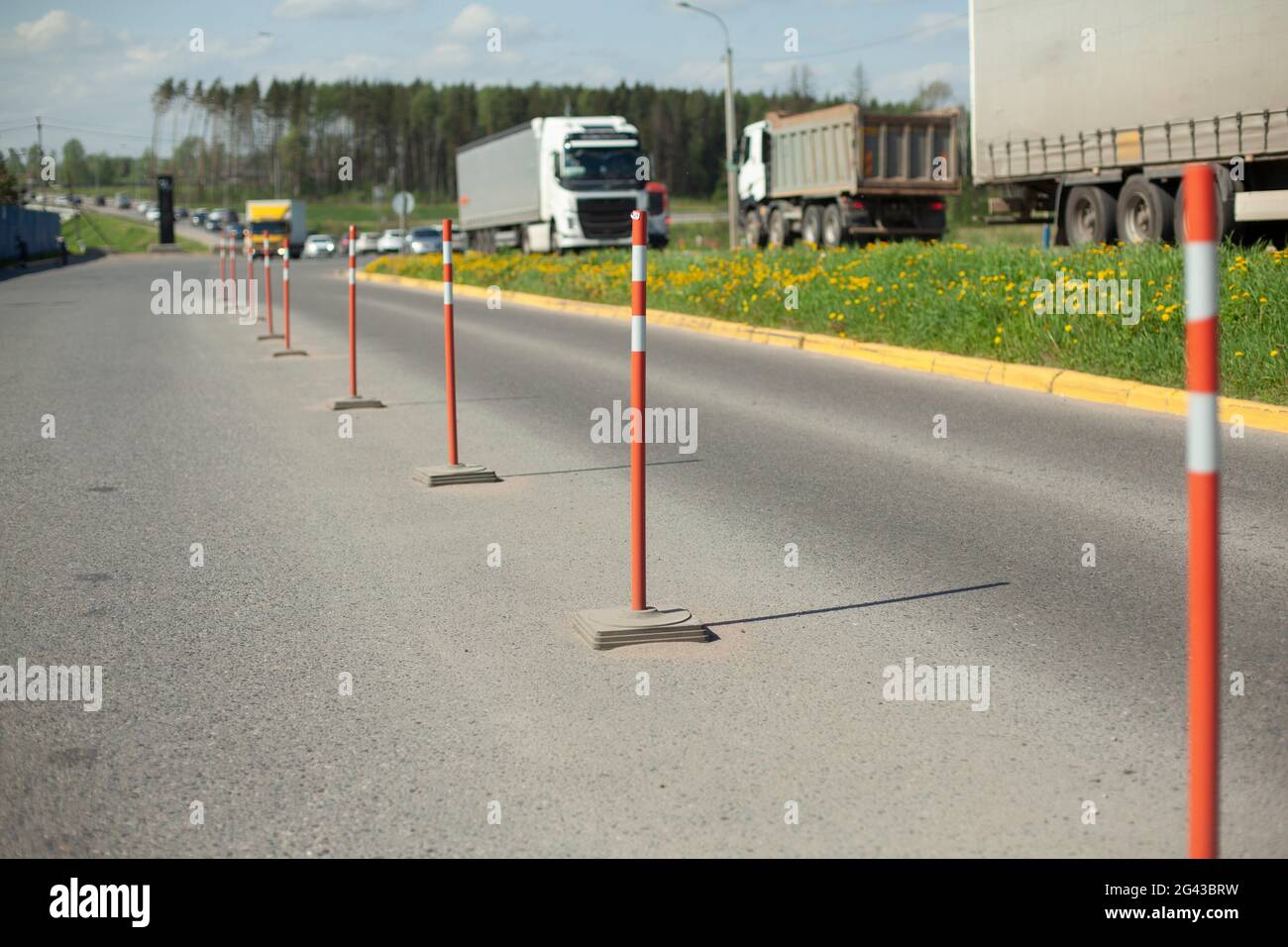 Red parking stops. Fencing the carriageway from cars. Bright orange ...