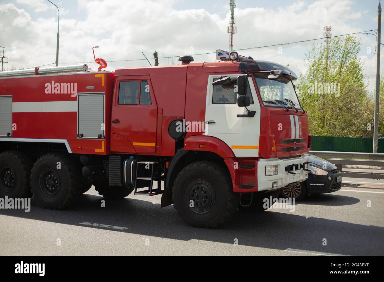 Fire truck on the road. The car goes to extinguish the fire. Rescuers ...
