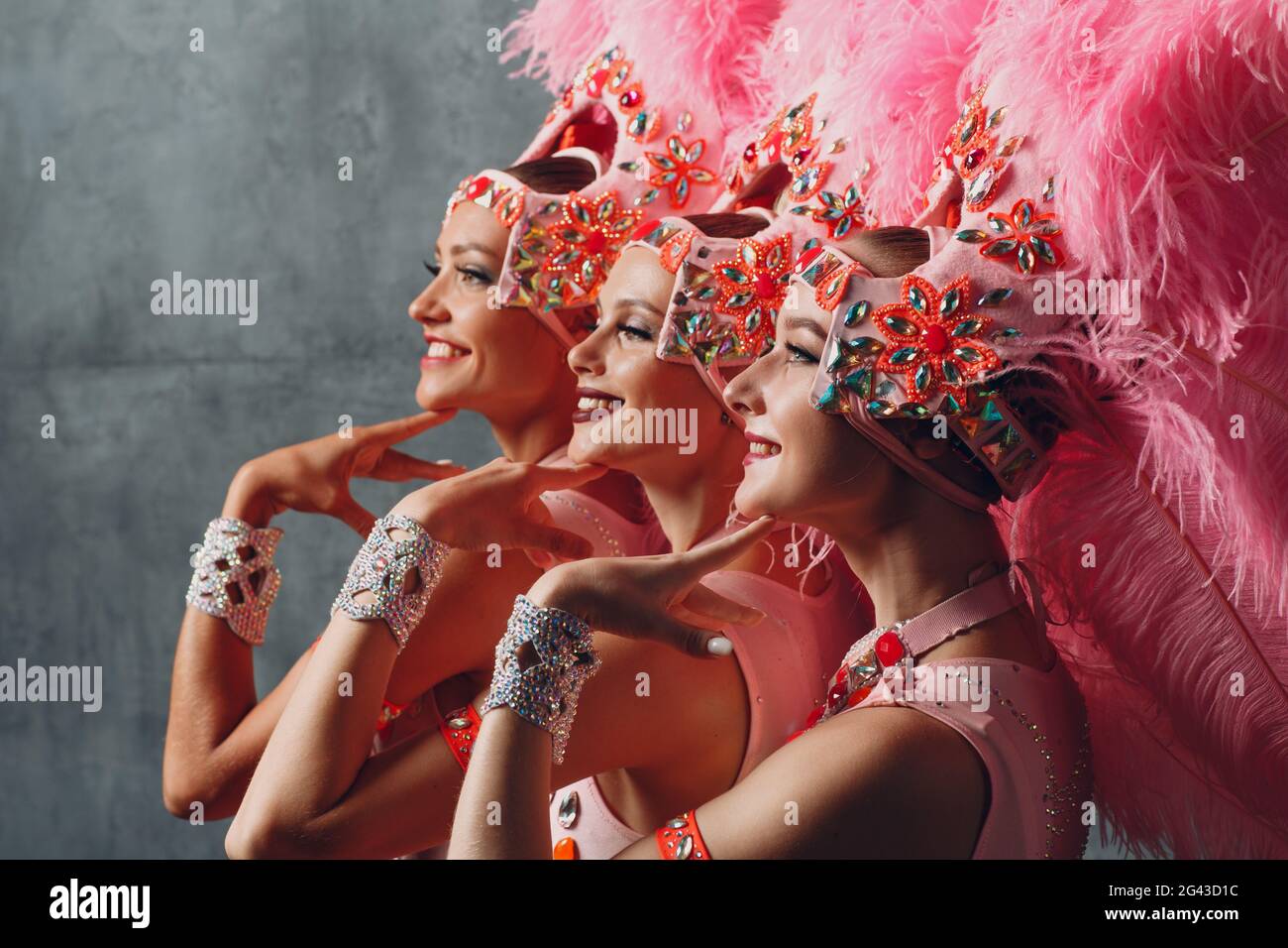Three Women profile portrait in samba or lambada costume with pink ...