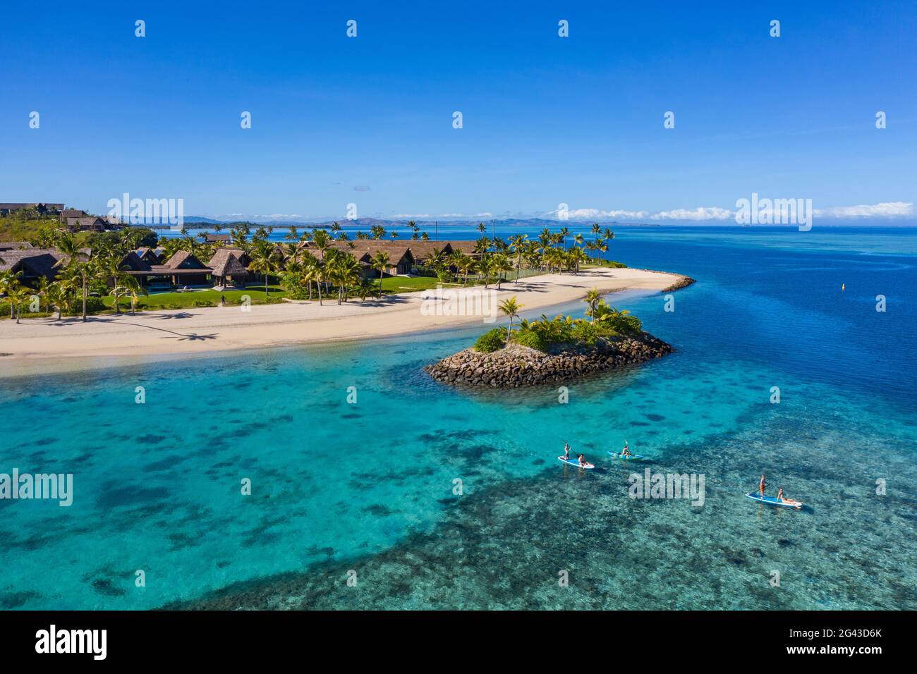 Aerial view of family enjoying water sports activities next to small ...
