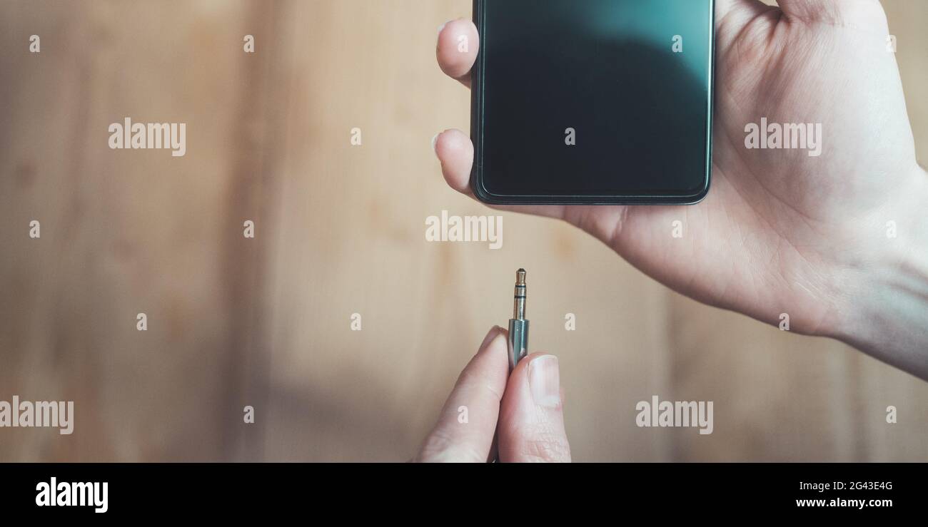 Audio jack concept: Connecting audio jack to a black mobile phone ...