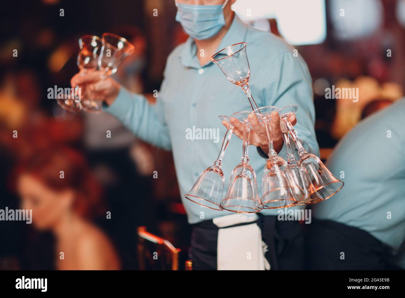 The waiter in the restaurant serves the tables and holds many ...