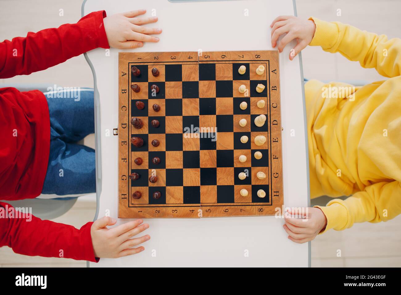 Little kids playing chess at kindergarten or elementary school. Top ...