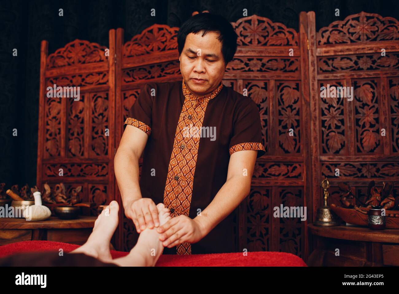 Thai man making classical thai massage procedure to young woman at ...