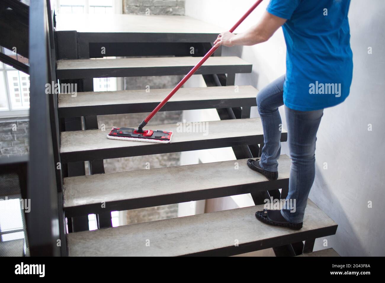 Cleaning service concept. Woman clean stair at home Stock Photo - Alamy