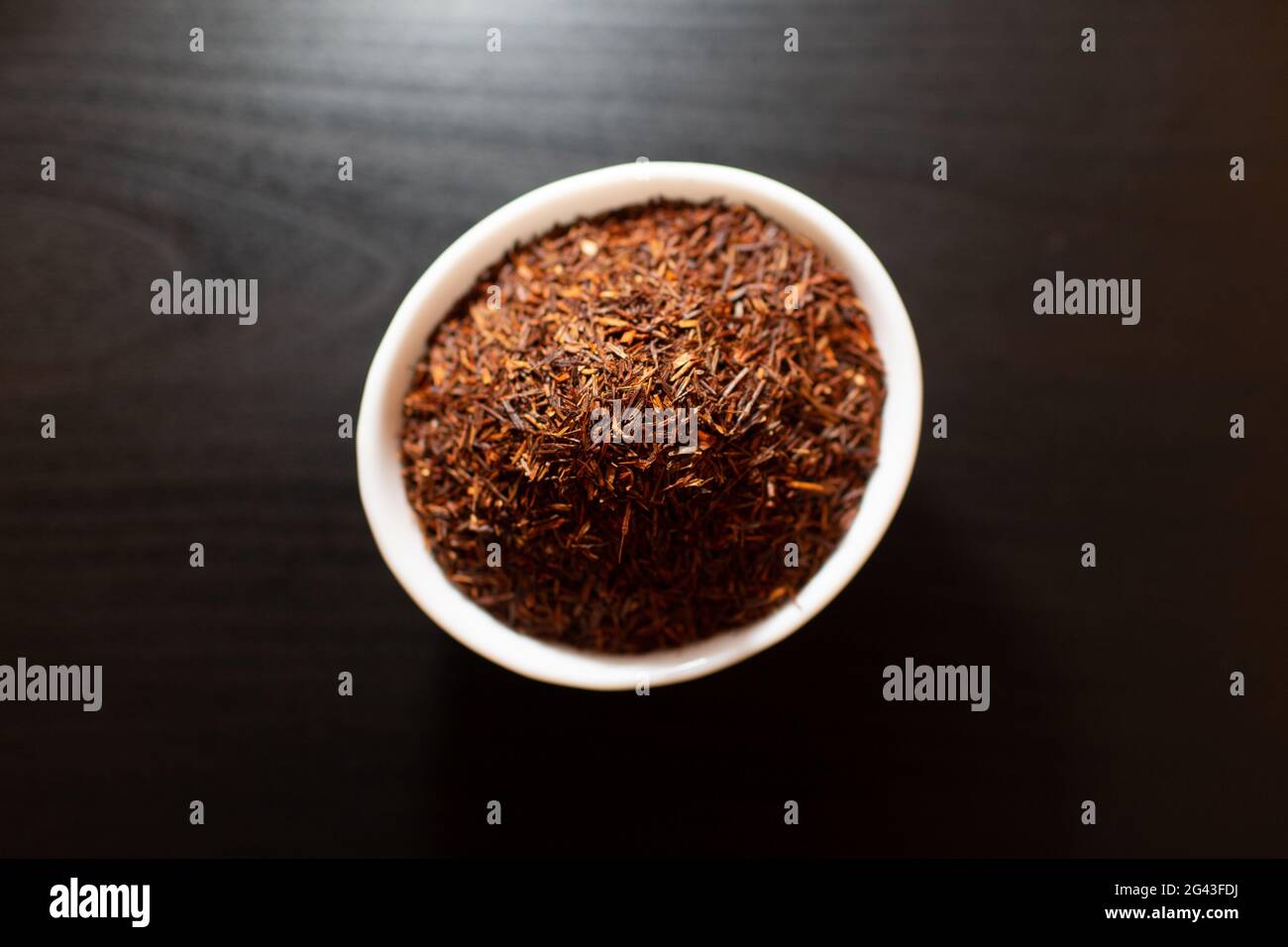 Rooibos tea on white plate on a wooden table Stock Photo - Alamy