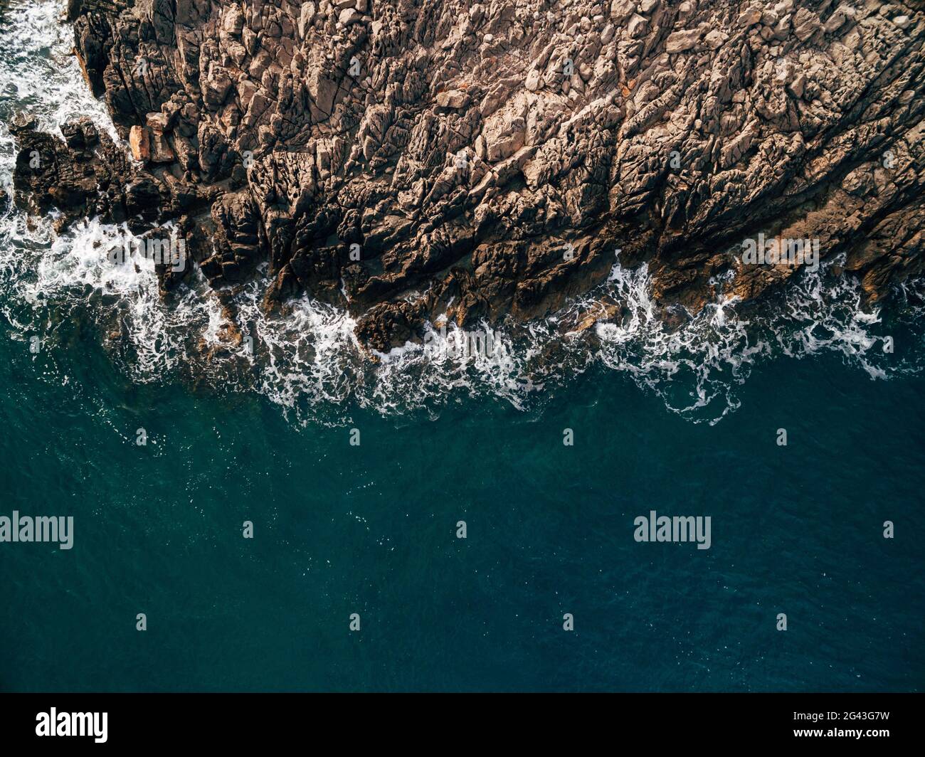 Top view of the blue sea with waves beating on beach and rocks Stock ...