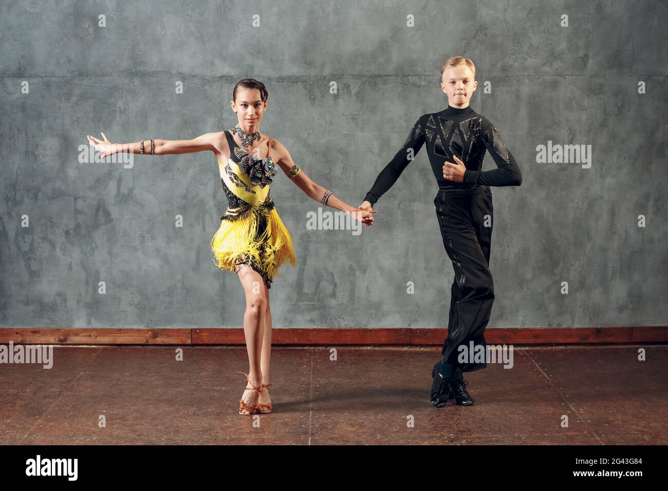 Young couple dancers dancing ballroom dance cha-cha-cha Stock Photo - Alamy