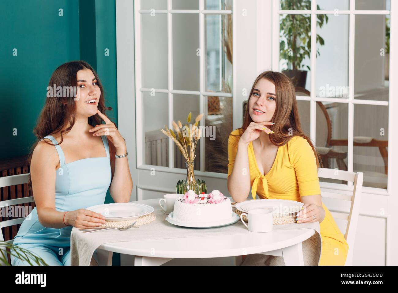 Women happy friends at home sitting and smiling with white birthday ...