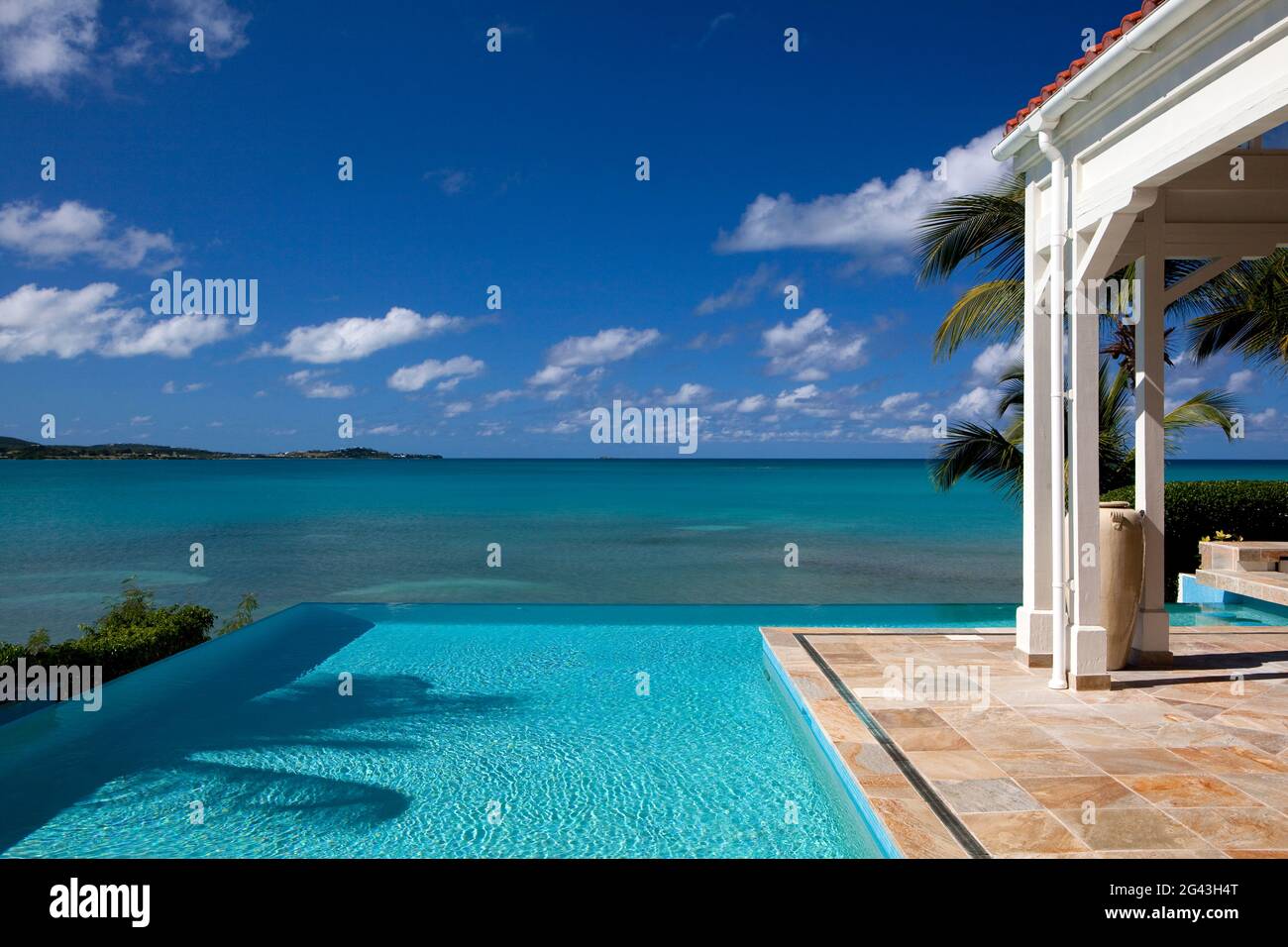 View of the ocean from an infinity pool and a bungalow beck. Antigua ...