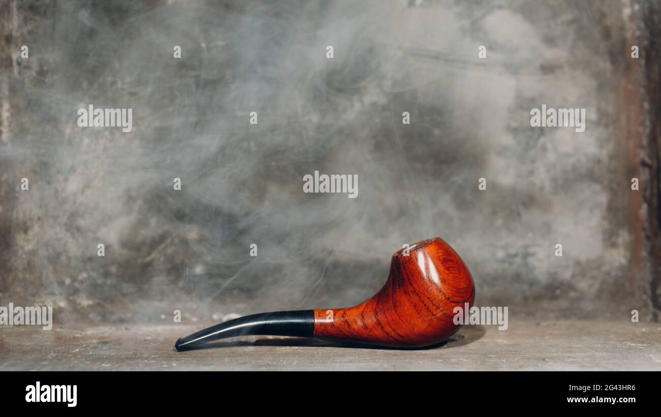 Smoking pipe on steel background with smoke Stock Photo - Alamy