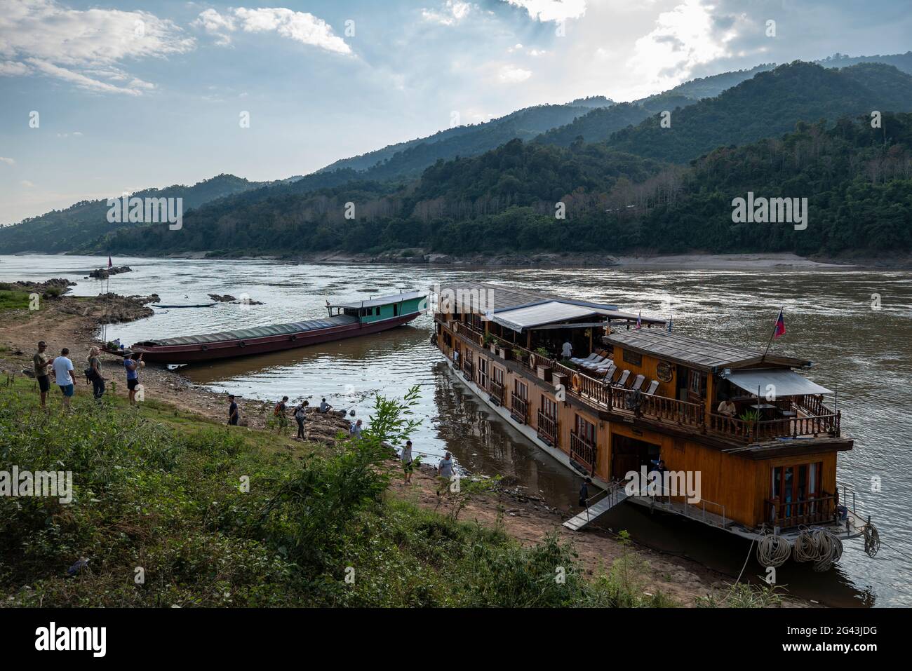 Passengers board the Mekong Sun river cruise ship on the banks of the ...