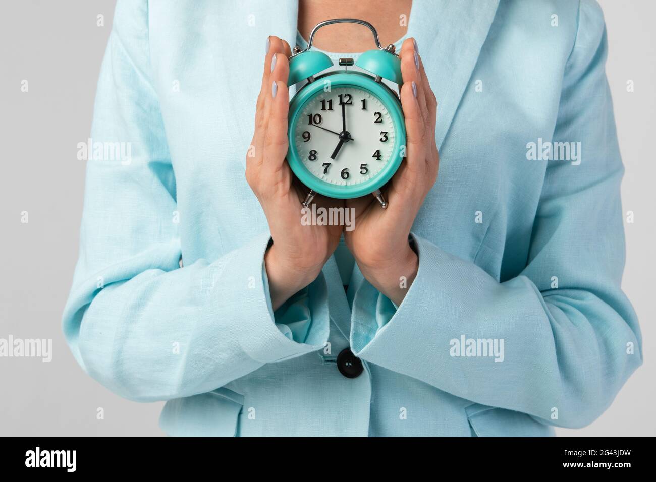 Woman holding clock in the hand Stock Photo - Alamy