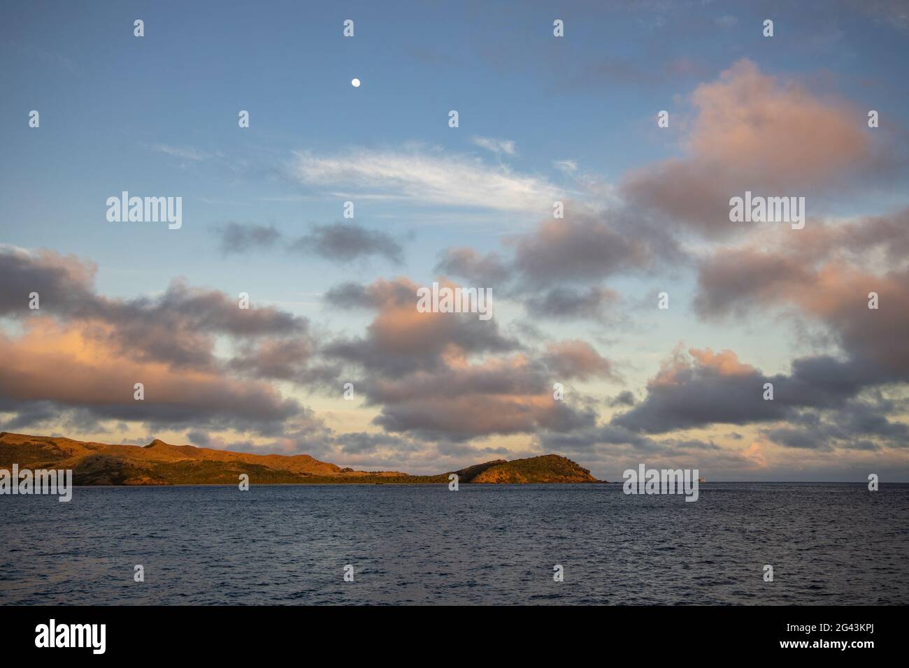 Clouds and moon over island at sunrise, Sawa-i-Lau Island, Yasawa Group ...