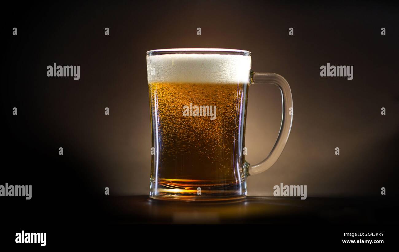 Glass of light beer on black background with spot light Stock Photo - Alamy