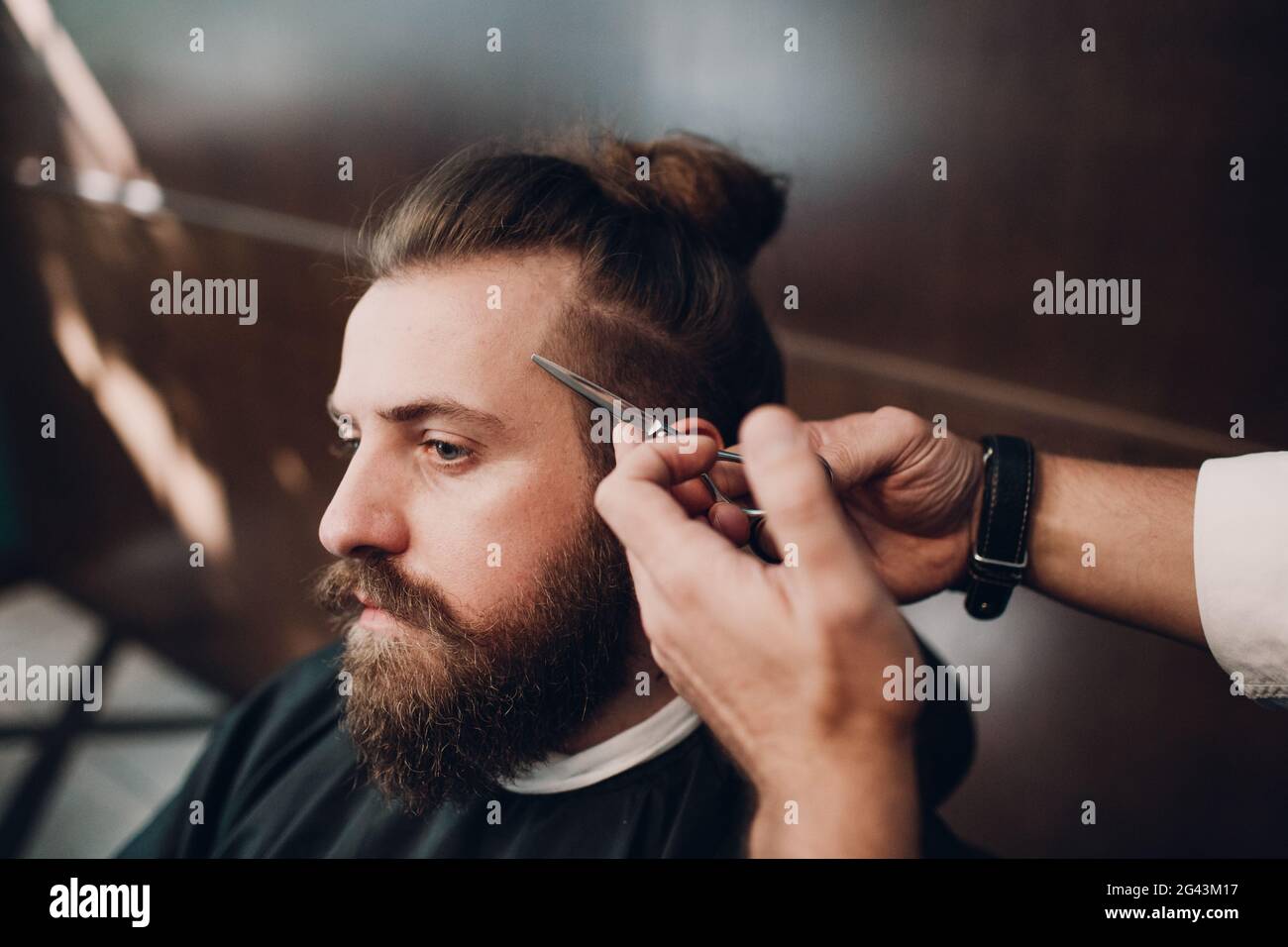 Barbershop with wooden interior. Bearded model man and barber Stock ...