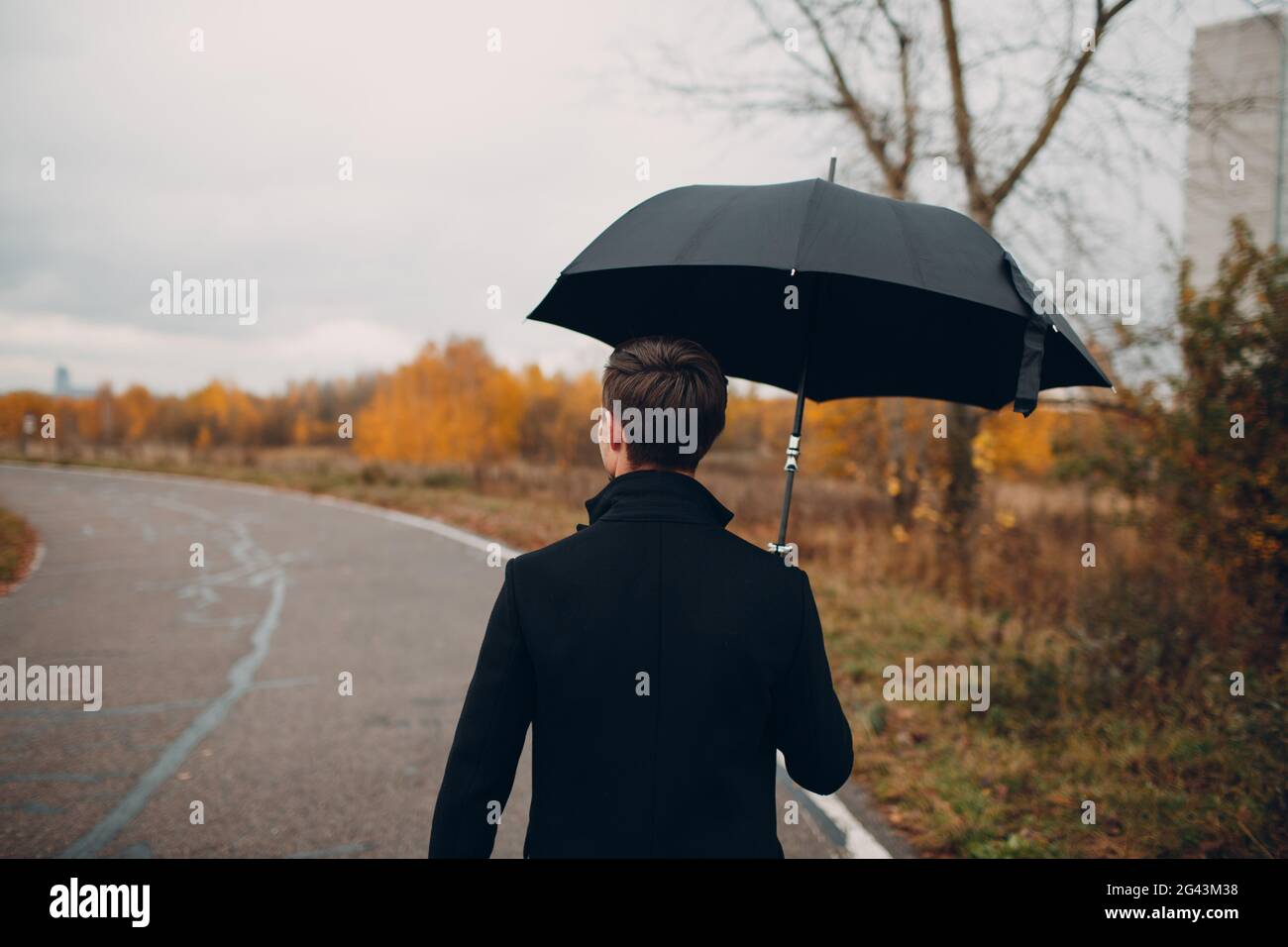 Man walking in rain umbrella hi-res stock photography and images - Alamy