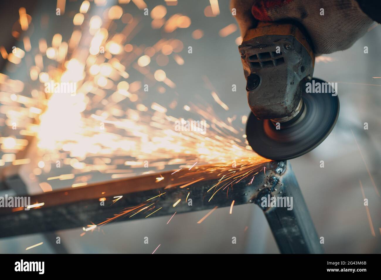 Craftsman sawing metal with disk grinder saw in workshop Stock Photo ...