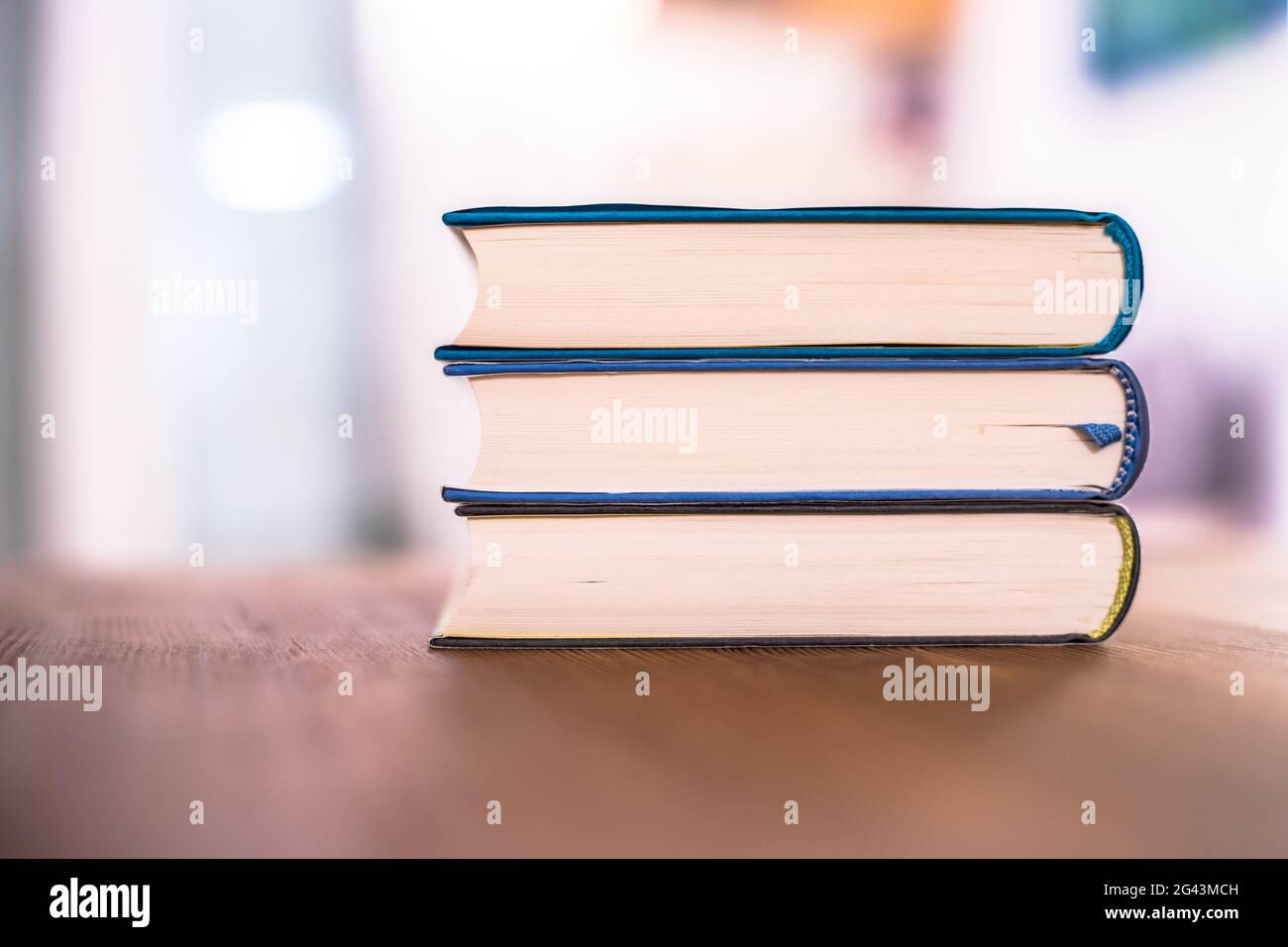 Knowledge and science concept: Stack of books lying on wooden desk ...