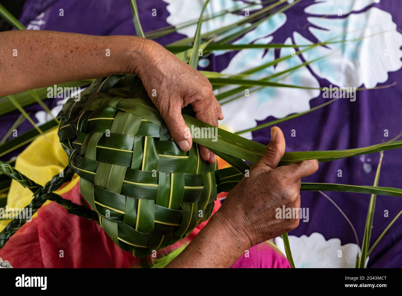 Traditional weaving with pandanus leaves during an immersion workshop ...