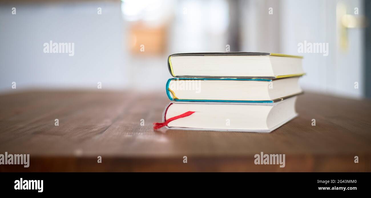 Knowledge and science concept: Stack of books lying on wooden desk ...