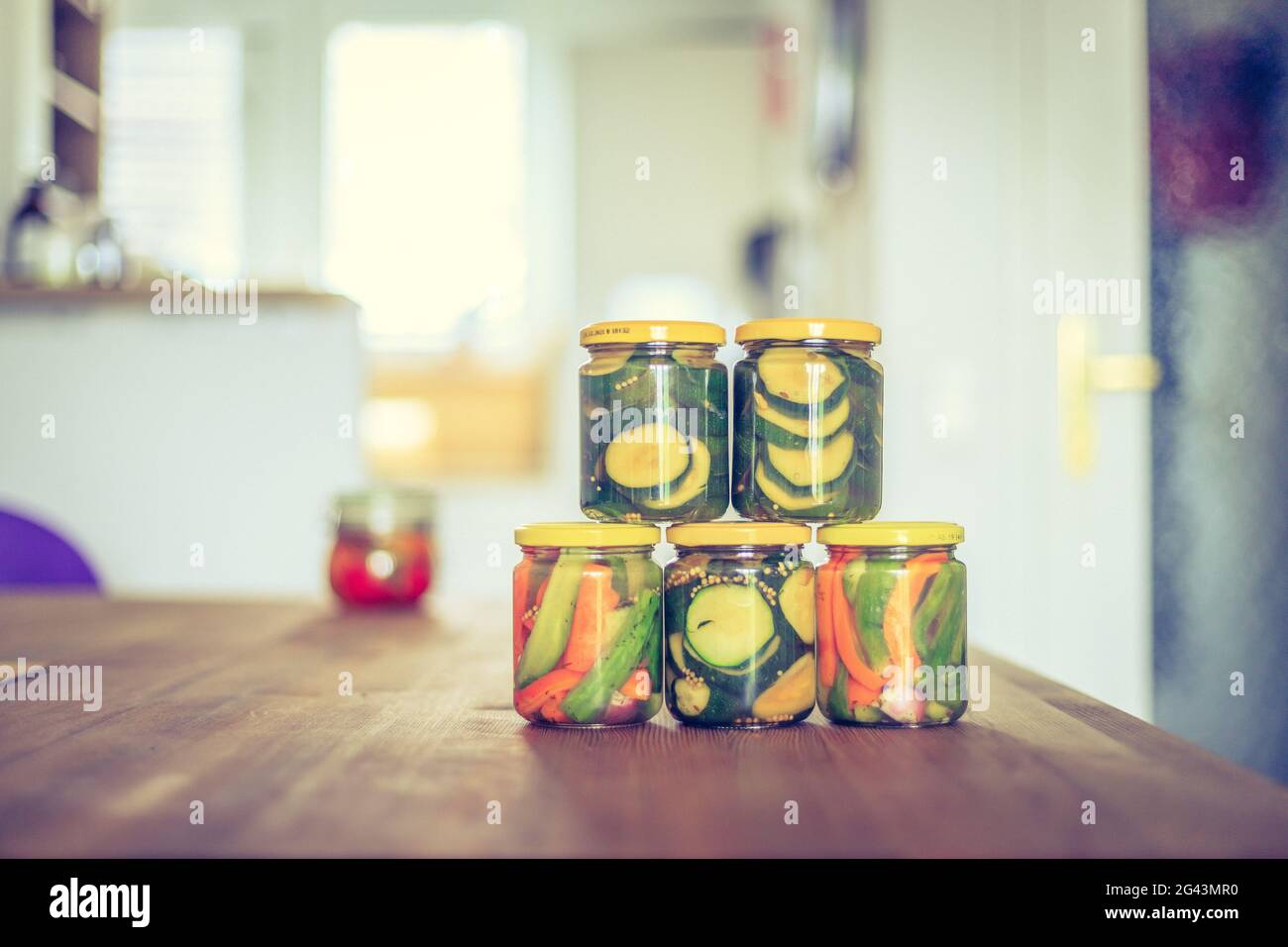 Variety of tasty vegetables in preserving glasses. Conservation of food ...