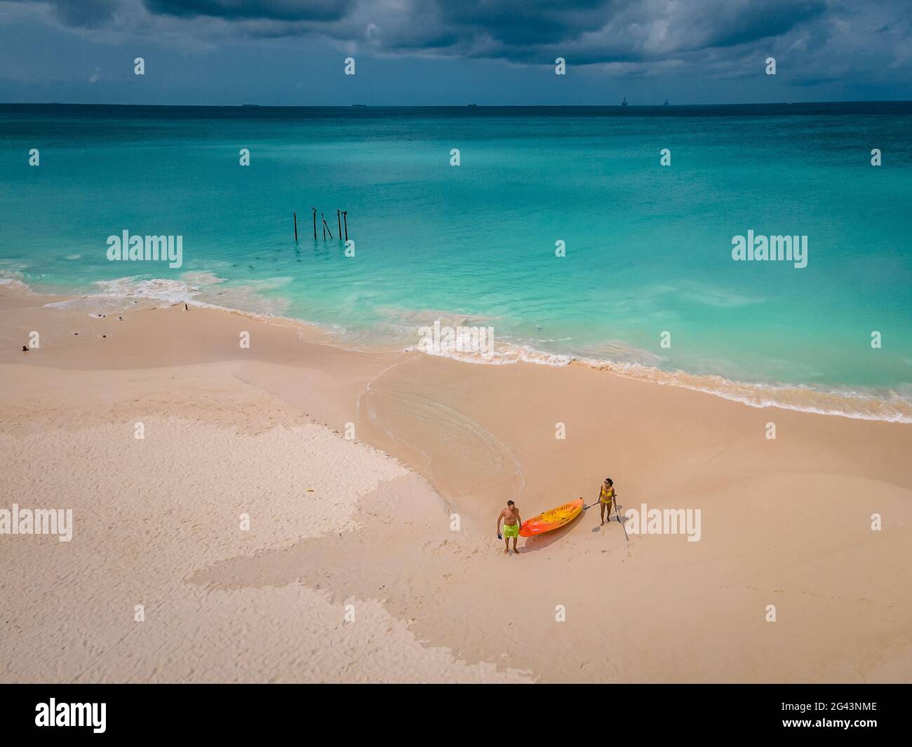 Aruba Caribbean couple men and woman mid age in kayak in blue ocean on ...