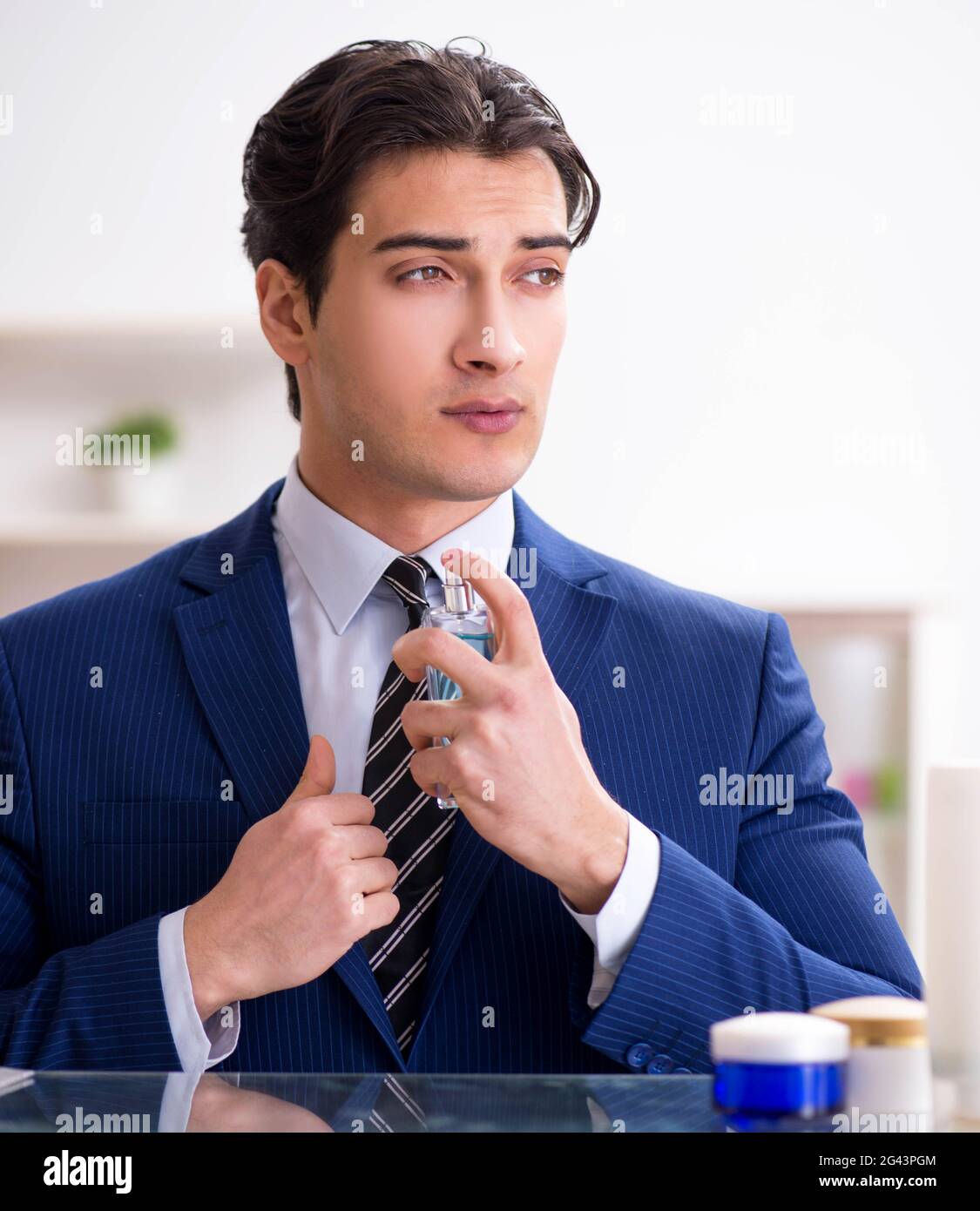 Man is getting dressed up for work in bathroom Stock Photo - Alamy