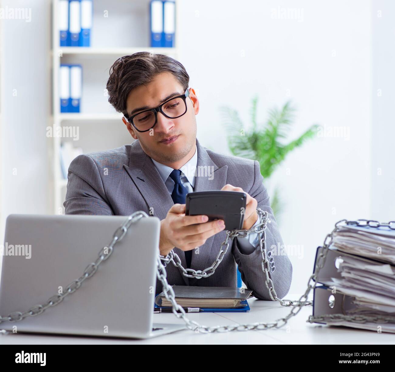 Man chained to desk hi-res stock photography and images - Alamy