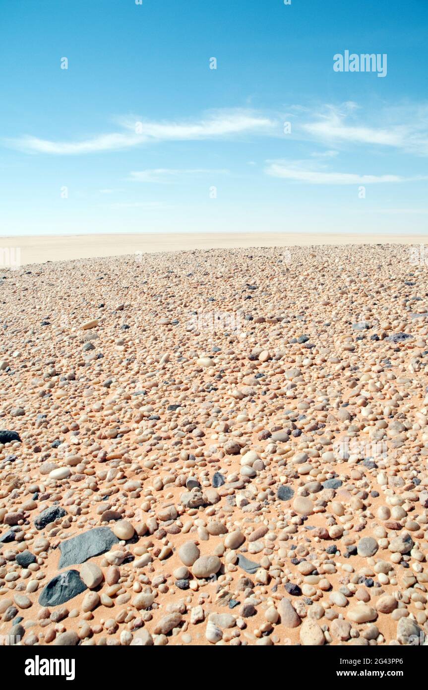 The desert floor littered with countless pebbles, part of an ancient ...
