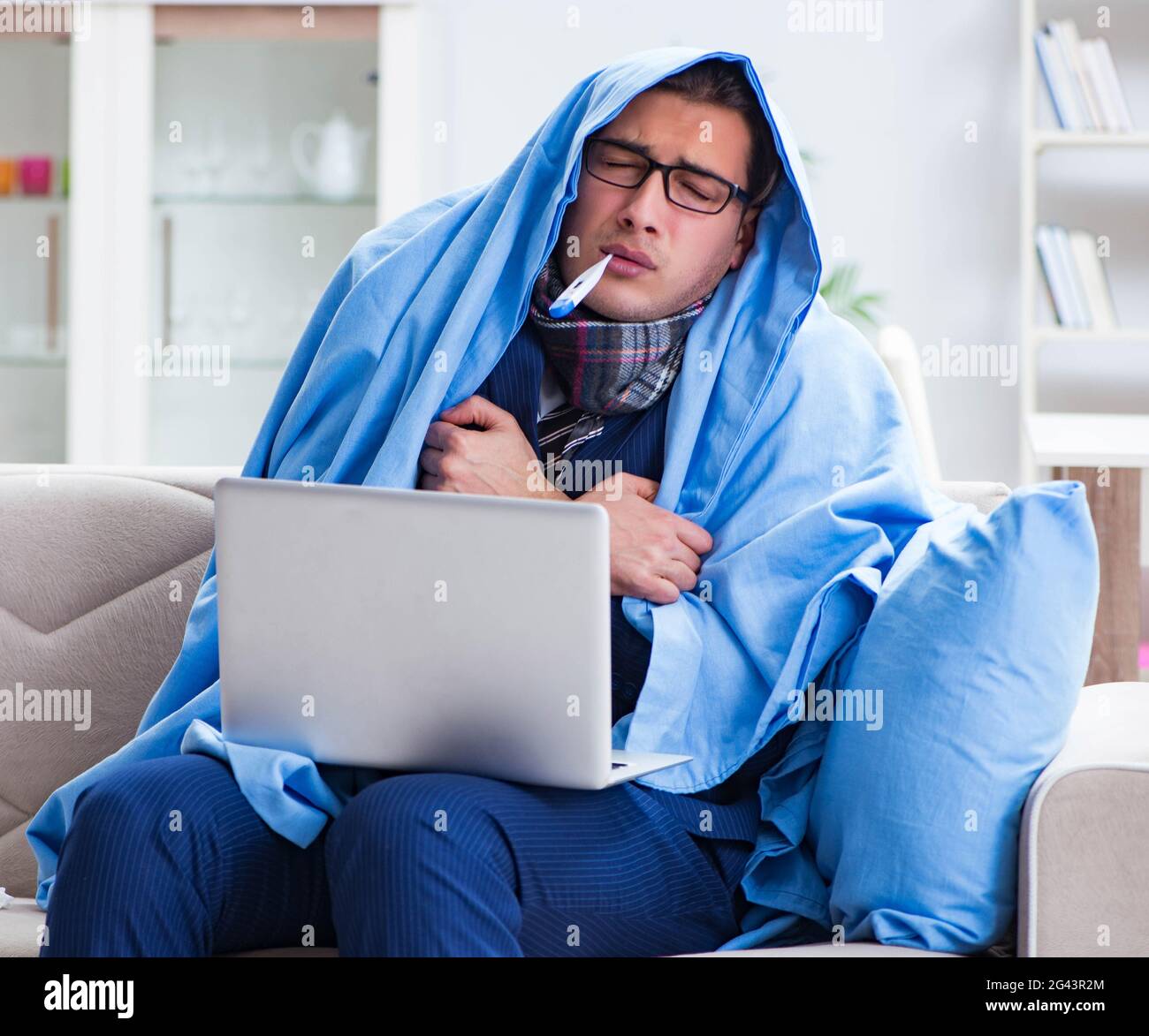 Sick businessman laptop computer temperature hi-res stock photography ...